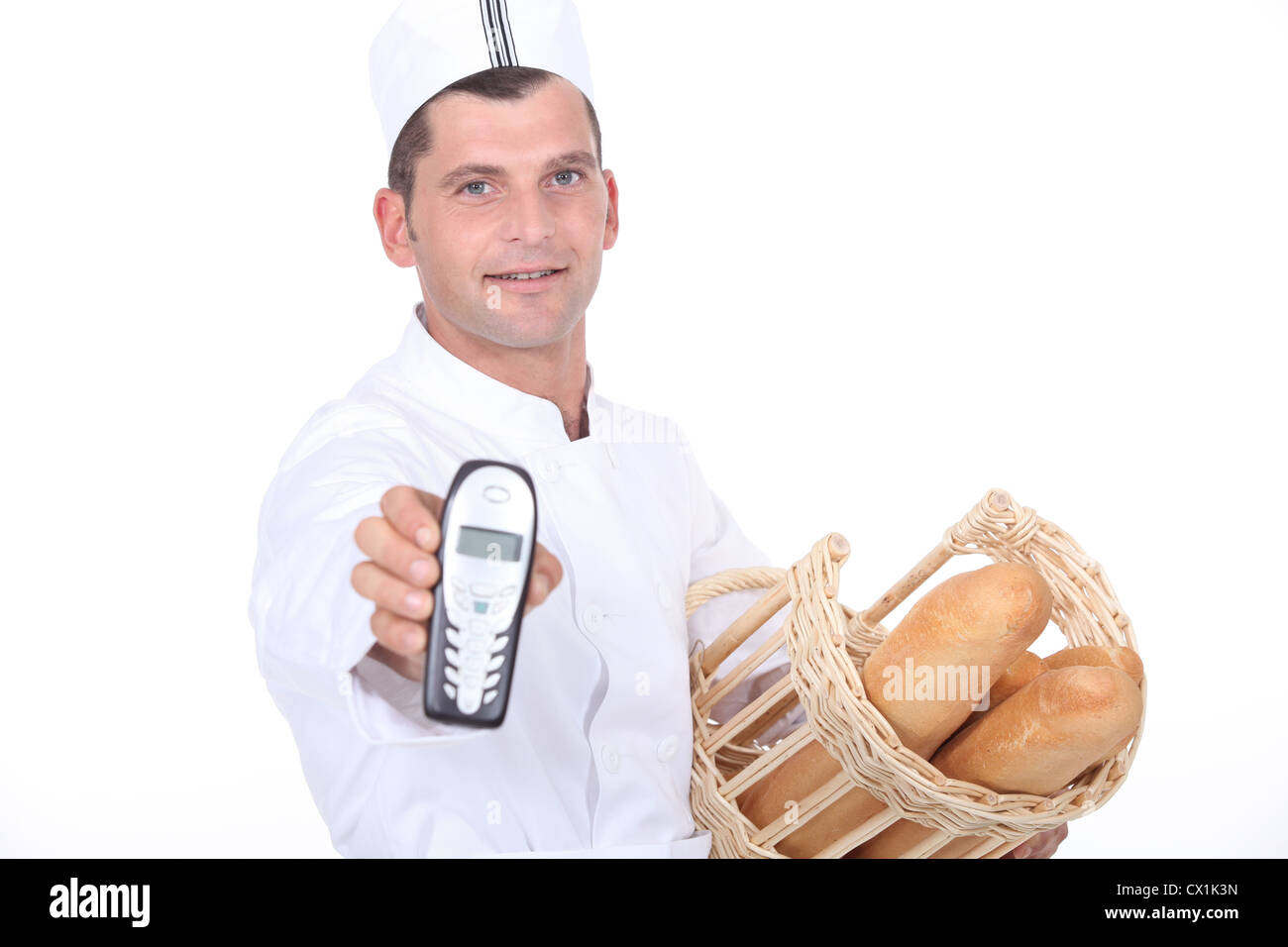 Baker with basket and phone Stock Photo - Alamy