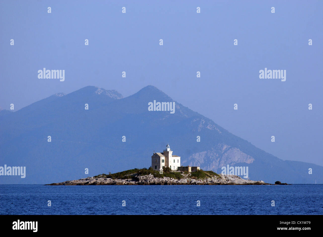 Lighthouse on small island Stock Photo - Alamy