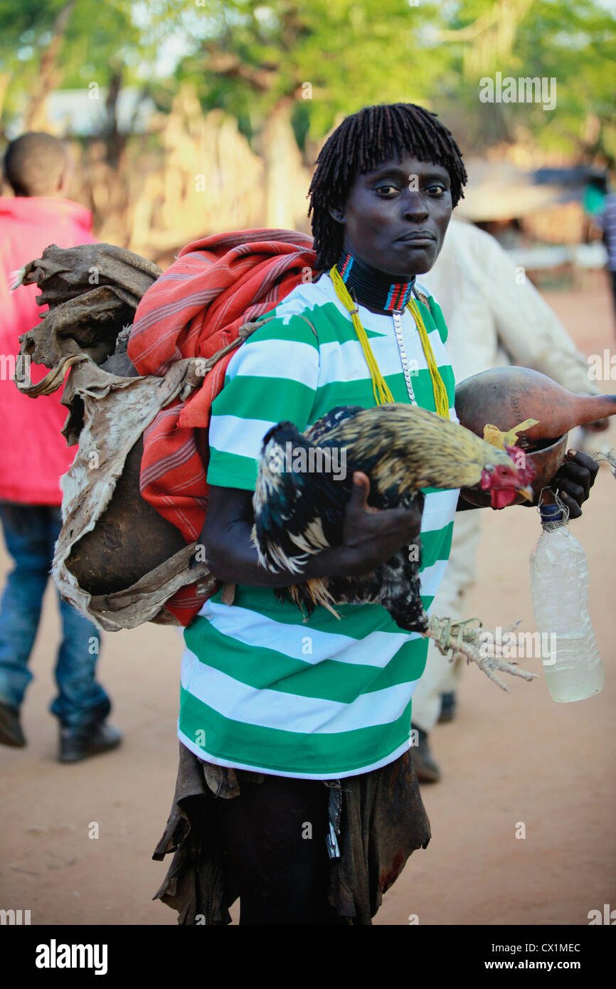 Tribal Hamar woman walking with her belongings Stock Photo - Alamy