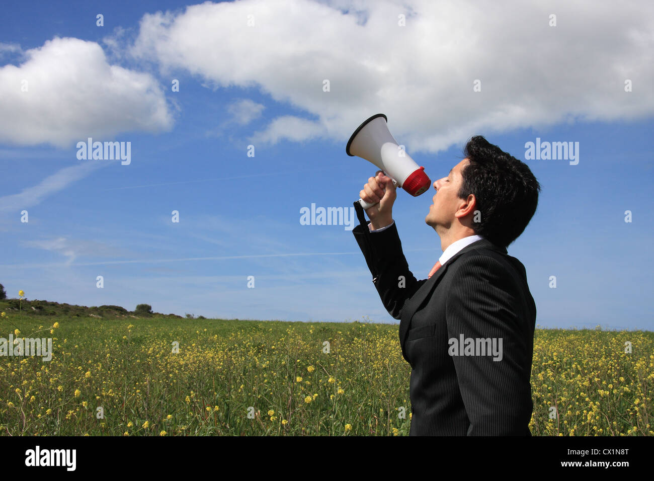A business man speaking to god with a megaphone Stock Photo - Alamy