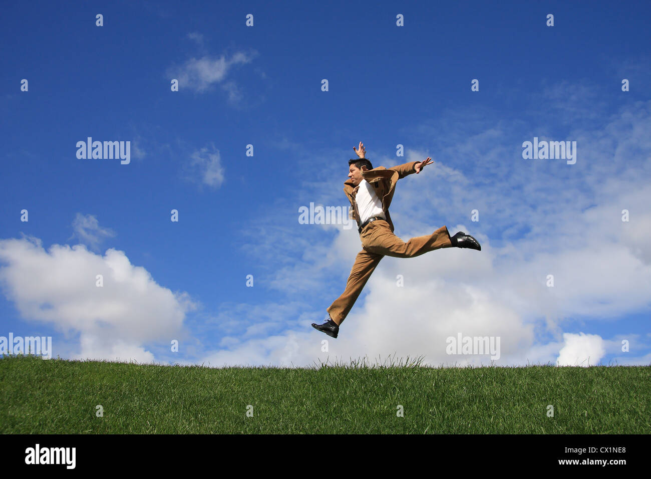 A happy business man jumping to the success Stock Photo - Alamy