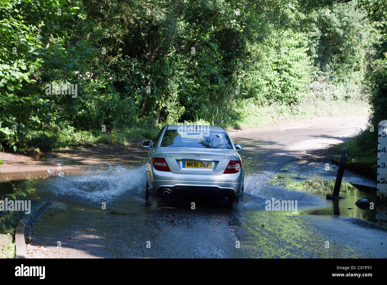 A car driving through a ford Stock Photo - Alamy