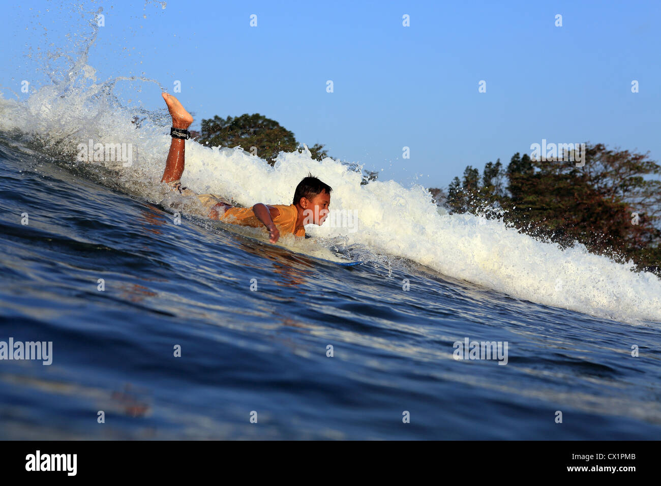 Young local boy surfing at Batu Karas in West Java, Indonesia Stock ...