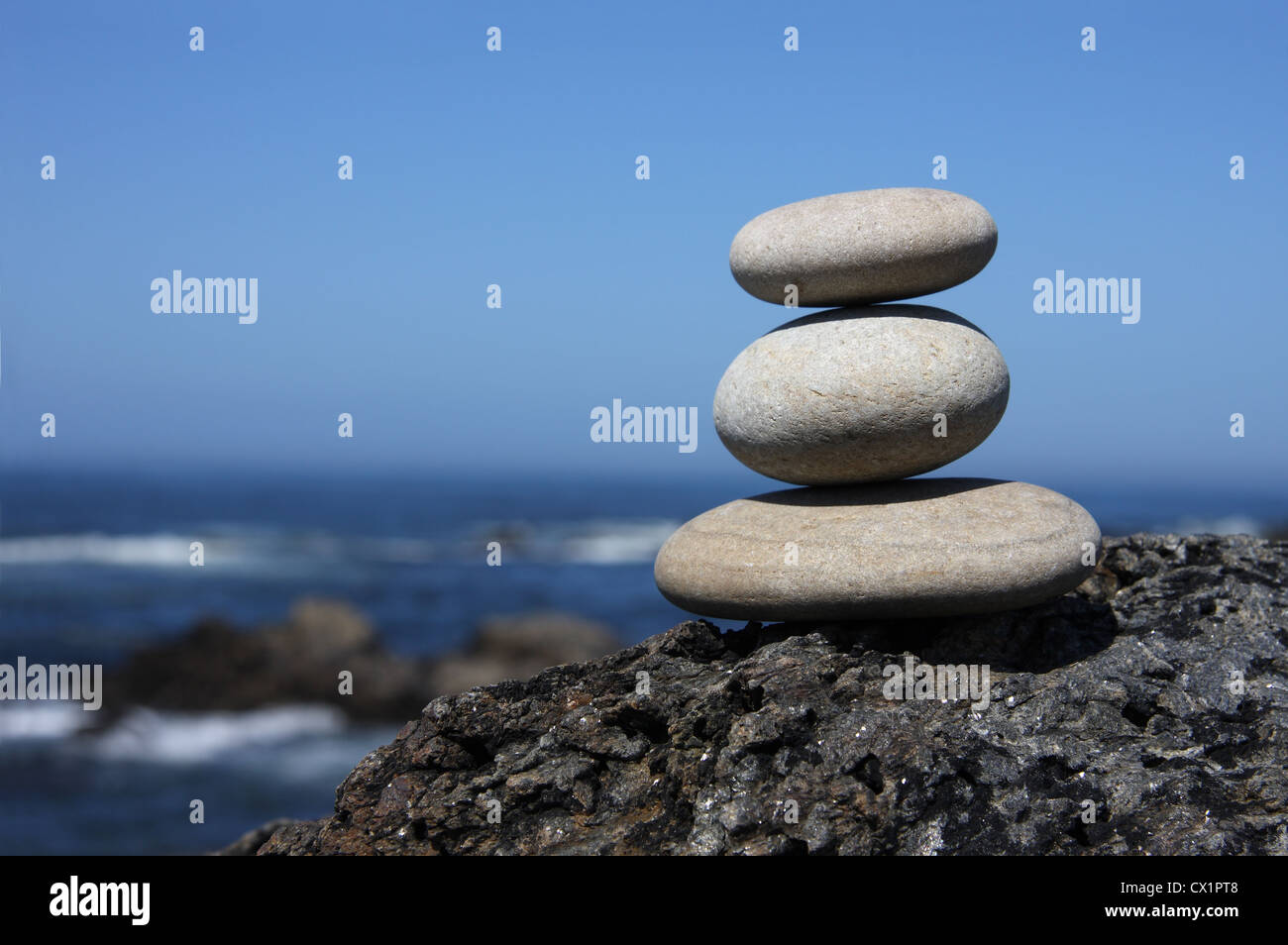 Pebbles stack on a volcanic rock near the sea Stock Photo - Alamy