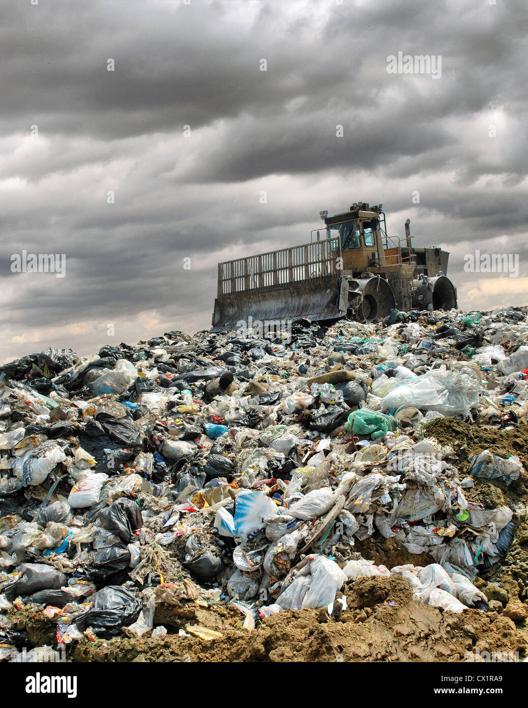 The bulldozer buries food and industrial wastes Stock Photo - Alamy