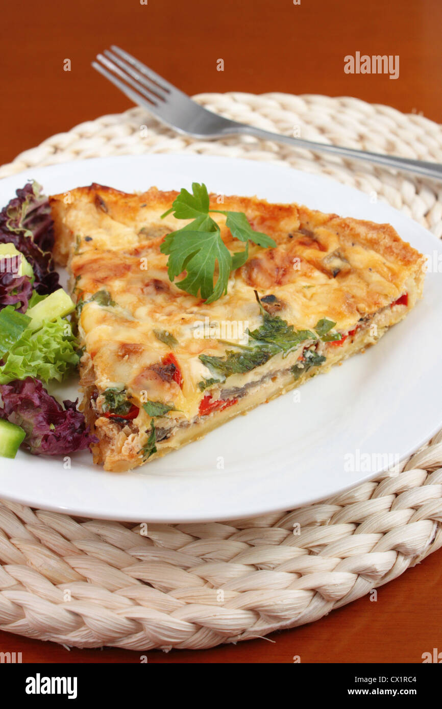 A slice of vegetable quiche Stock Photo - Alamy