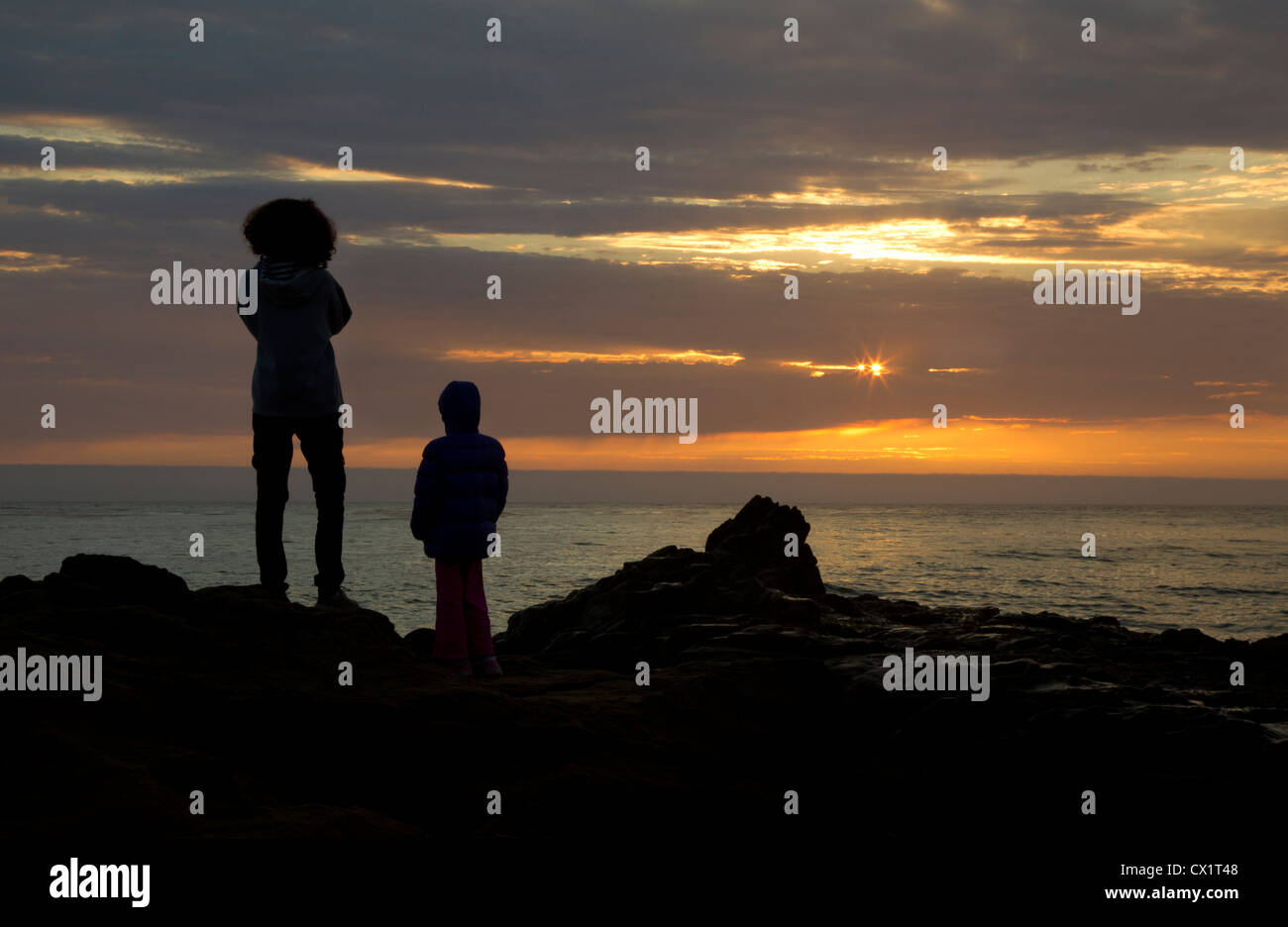 Two People Watching Sunset over Pacific Ocean Stock Photo - Alamy