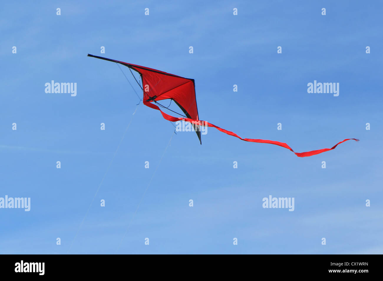 Big red kite flying in the blue sky Stock Photo - Alamy