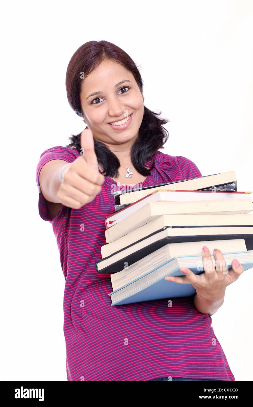 Successful young female student giving thumbs up gesture Stock Photo ...