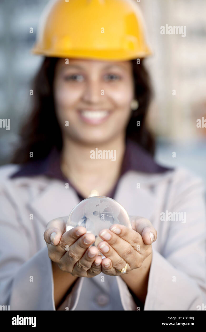 Young female Industrial engineer holding a glass globe Stock Photo - Alamy