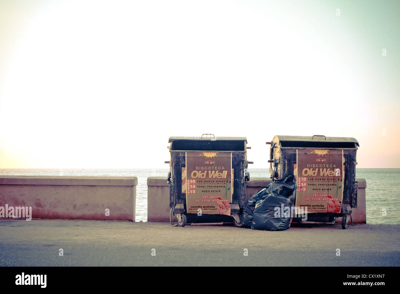Garbage containers with a poster Stock Photo - Alamy