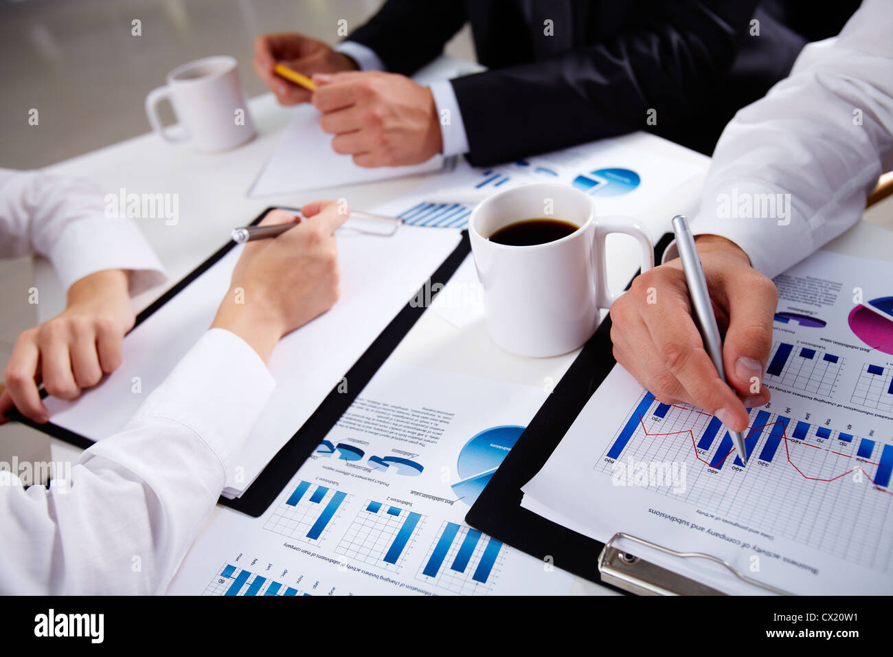 Hands of business people during paperwork Stock Photo - Alamy