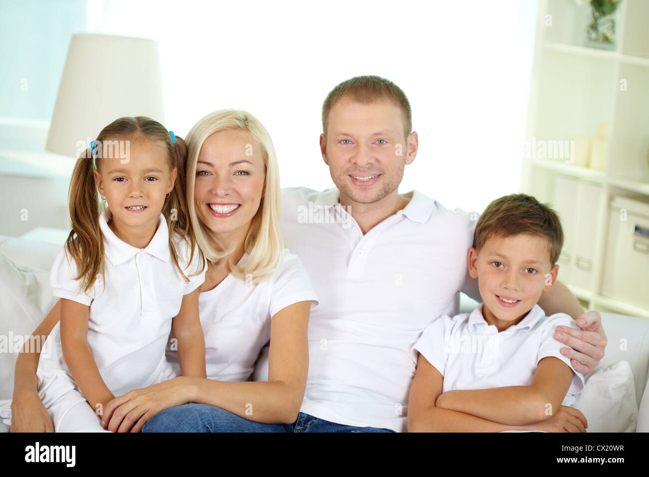 Portrait of happy family with two children smiling at camera Stock ...