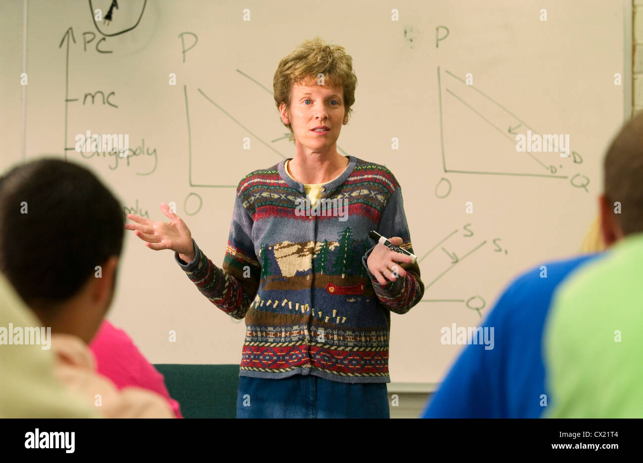 A female math teacher lectures in a college classroom Stock Photo - Alamy
