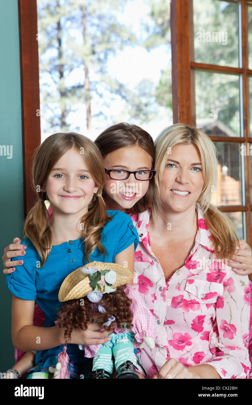 Portrait of mother and daughters smiling Stock Photo - Alamy