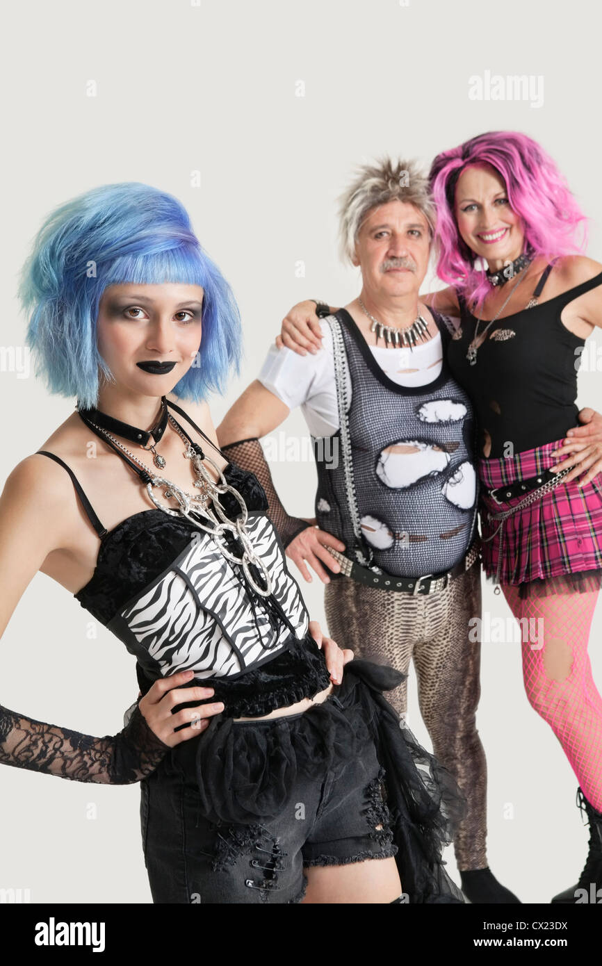 Group portrait of young female punk with senior couple standing in ...