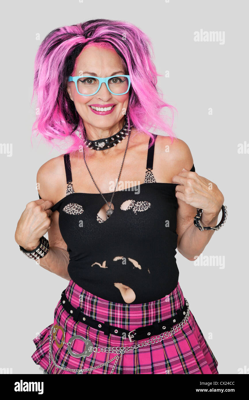 Portrait of senior female punk posing over gray background Stock Photo ...