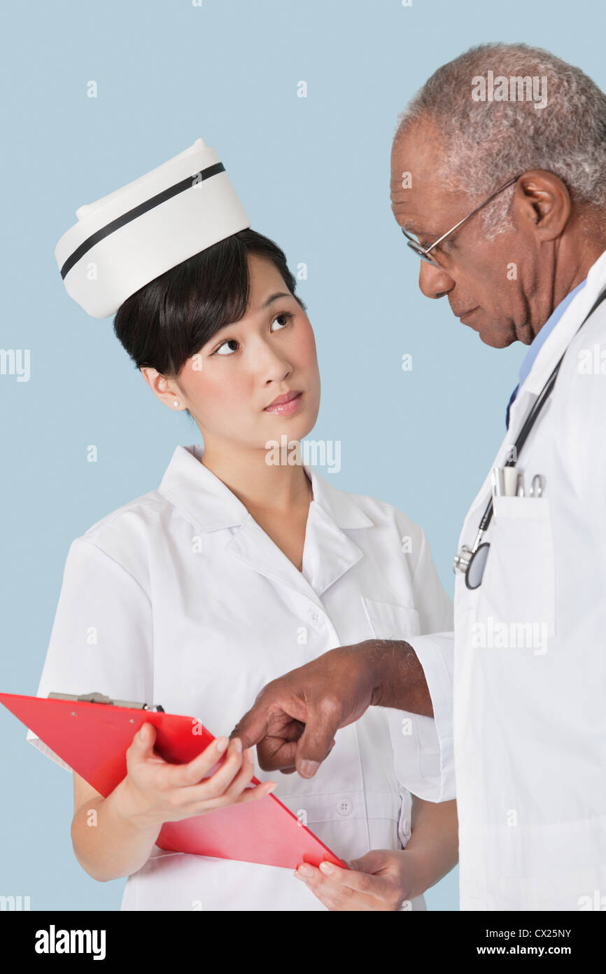Two medical professionals having a discussion over medical report ...