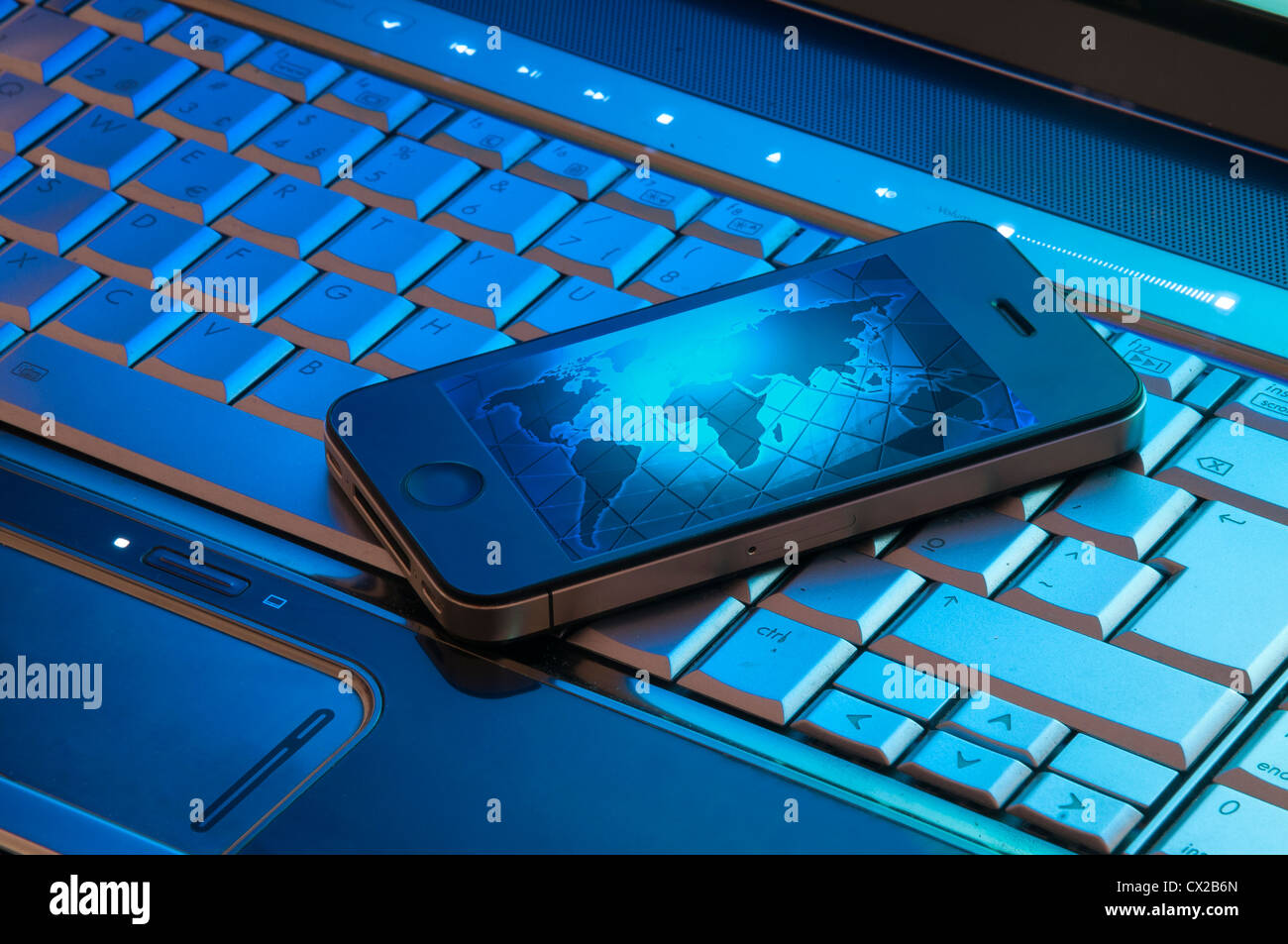 Computer keyboard and cellphone in a beautiful shade of blue Stock ...