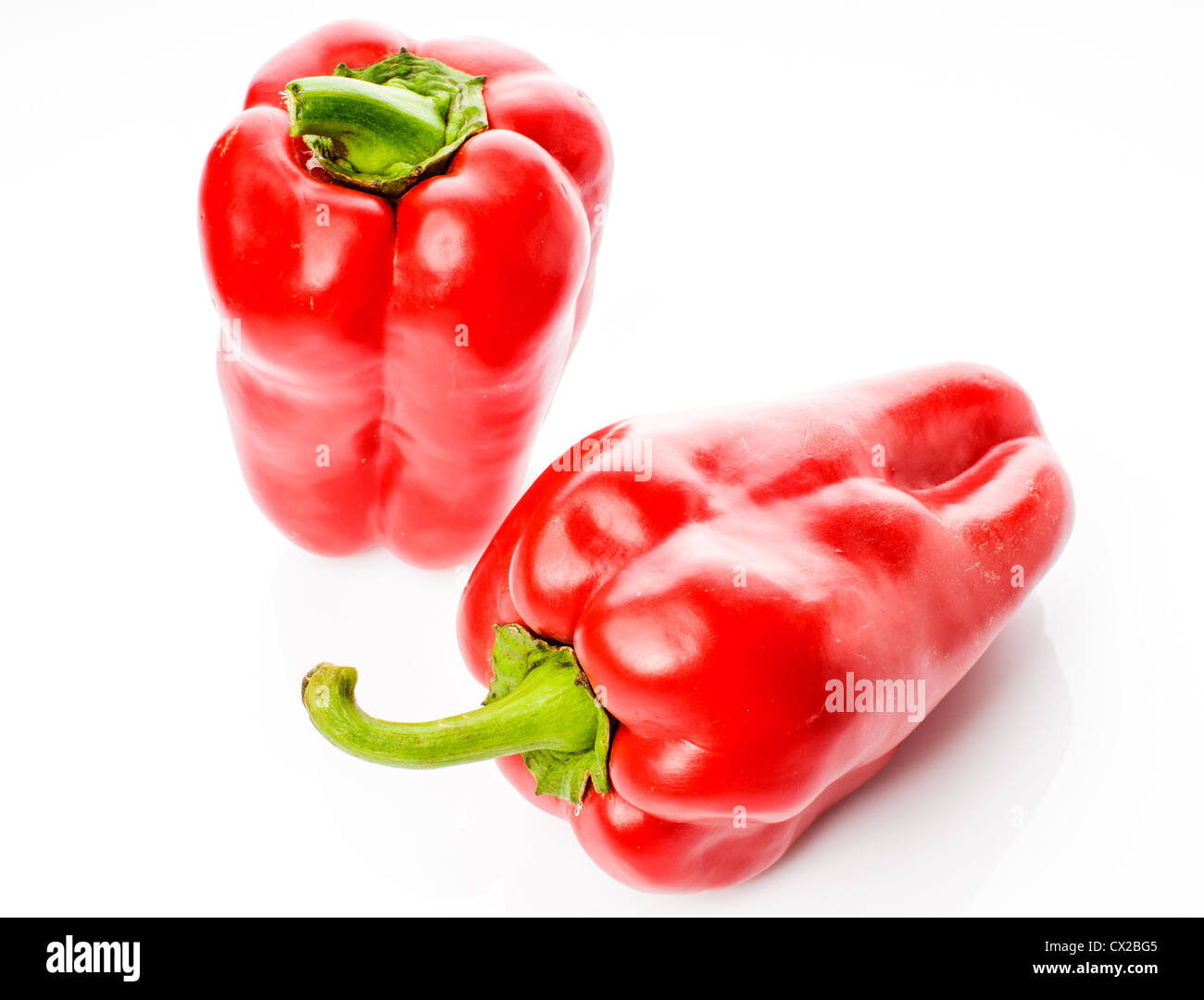 Two big red peppers isolated on white background Stock Photo - Alamy