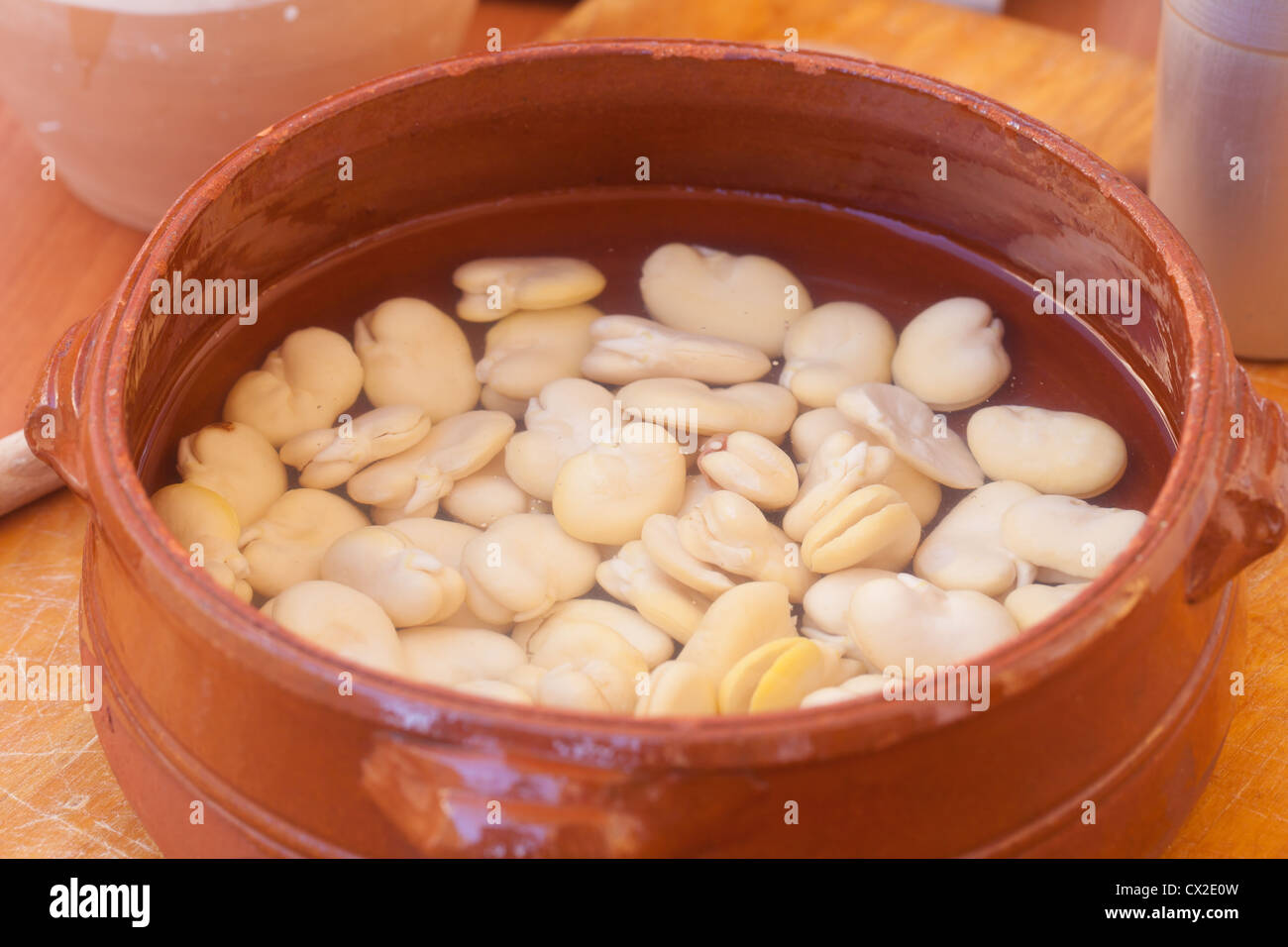 Ceramic pot of raw broad beans underwater before preparation Stock ...