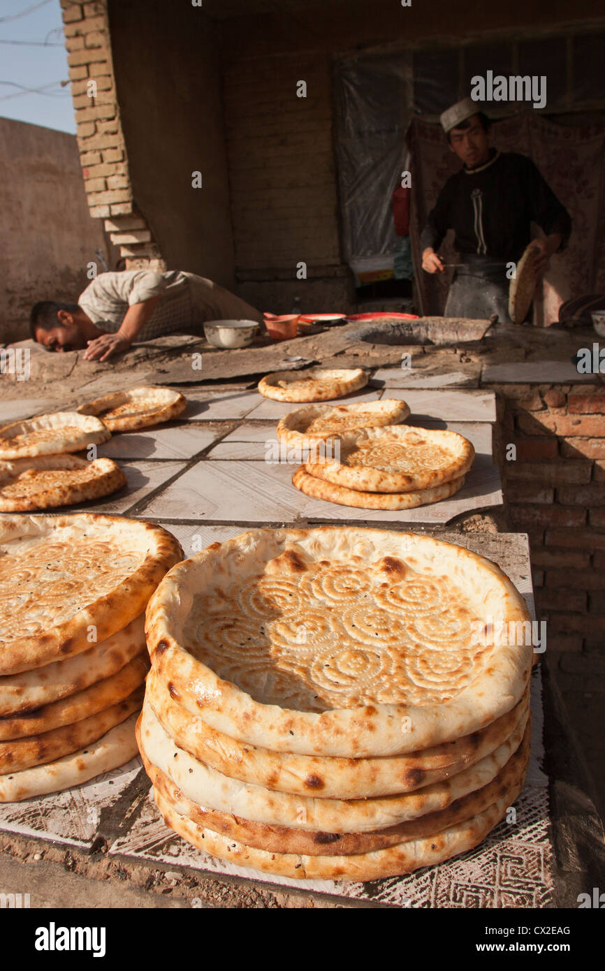 Uighur bakers make naan flat bread in Turpan, Xinjiang, China Stock ...