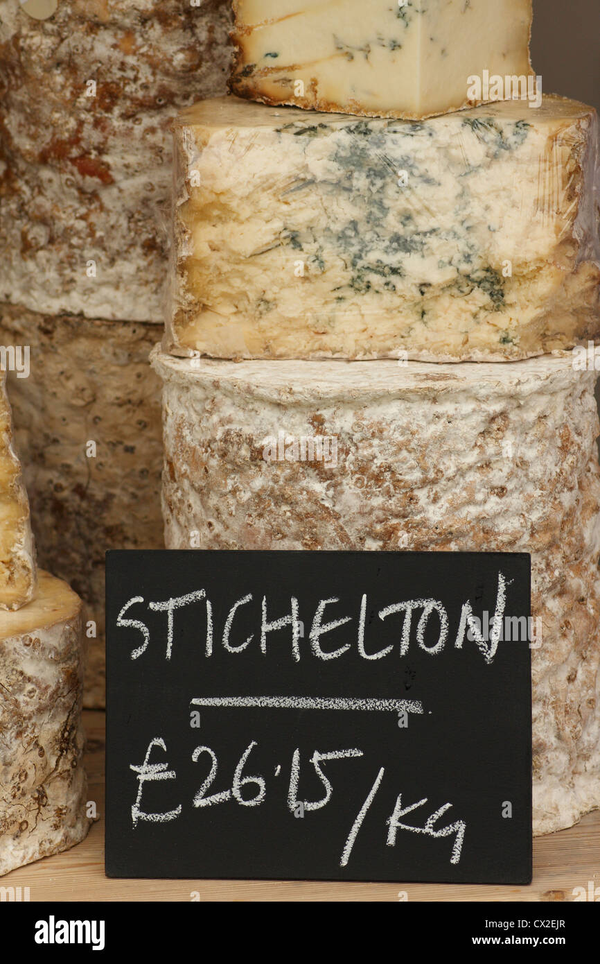 Pile/quarters of blue Stichelton cheeses for sale Stock Photo - Alamy