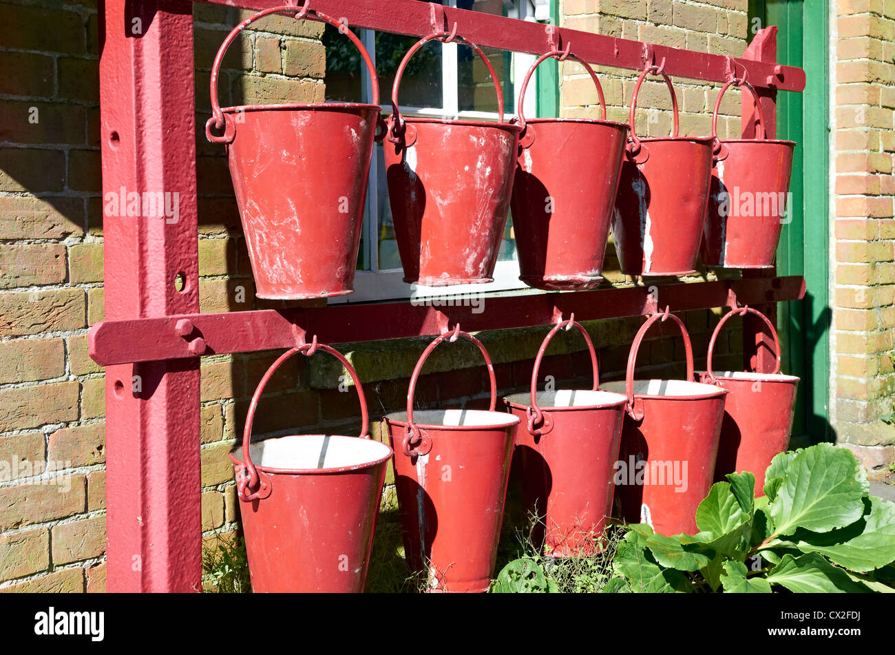 Red fire buckets outside a preserved railway station Stock Photo - Alamy