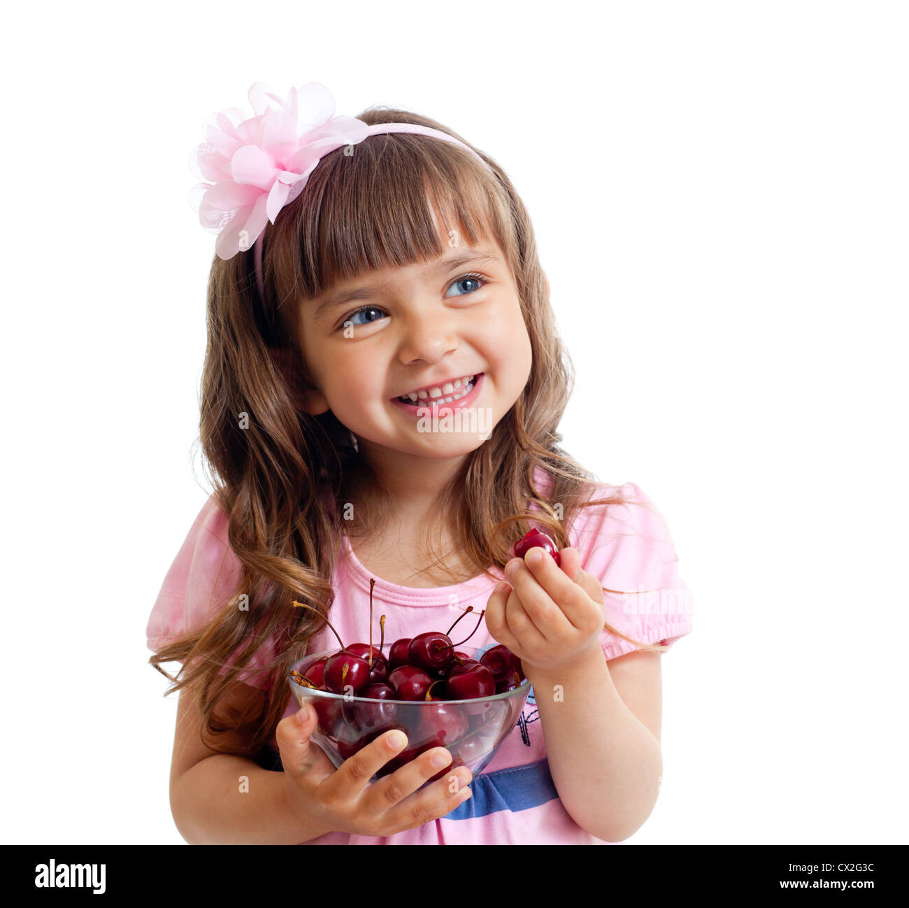 little girl with cherry berries bowl in studio isolated Stock Photo - Alamy