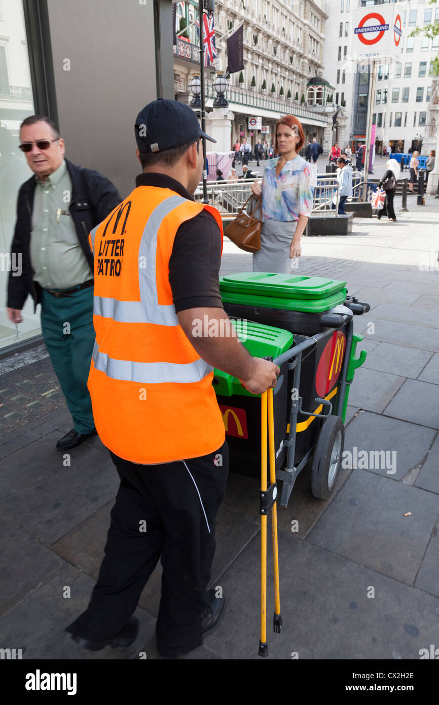 McDonalds litter patrol operative with bin in the Strand London Stock ...