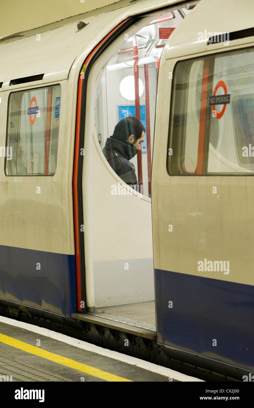 London underground man sitting hi-res stock photography and images - Alamy