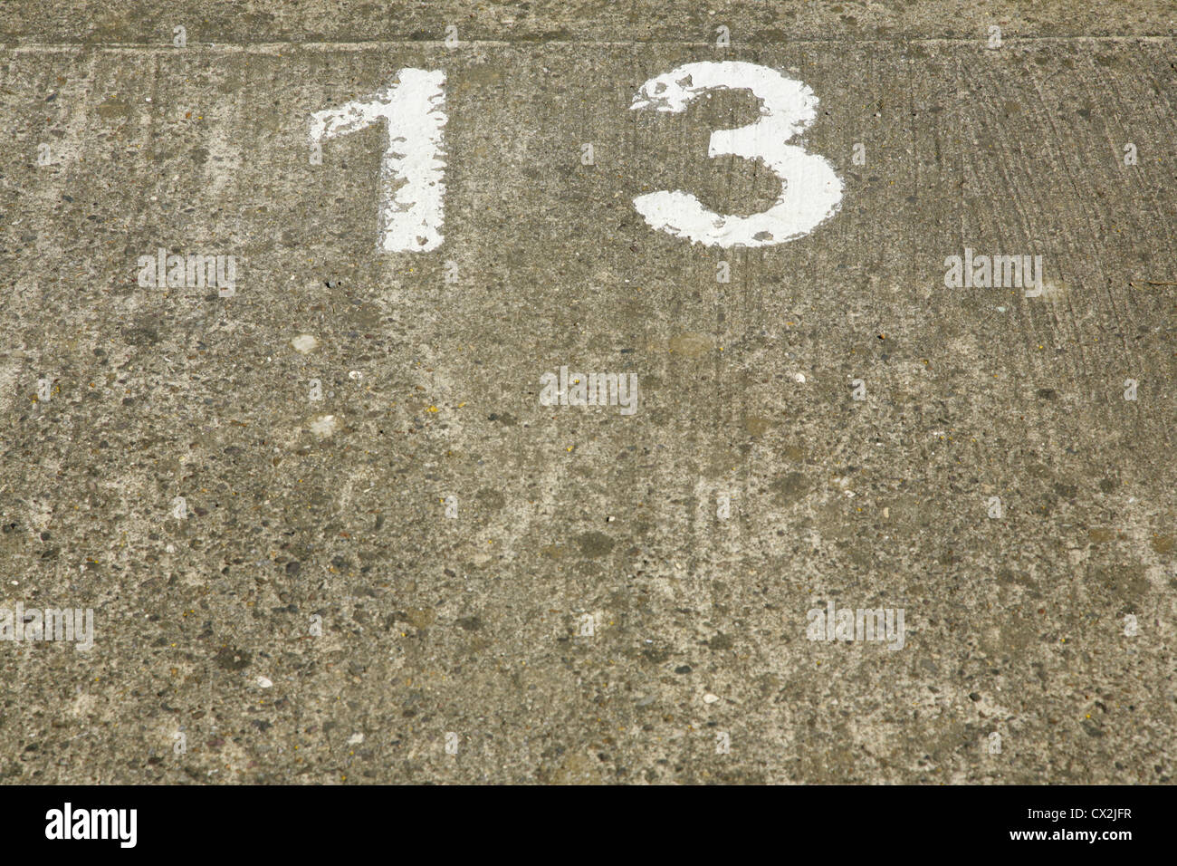 Number 13 painted onto concrete surface Stock Photo - Alamy