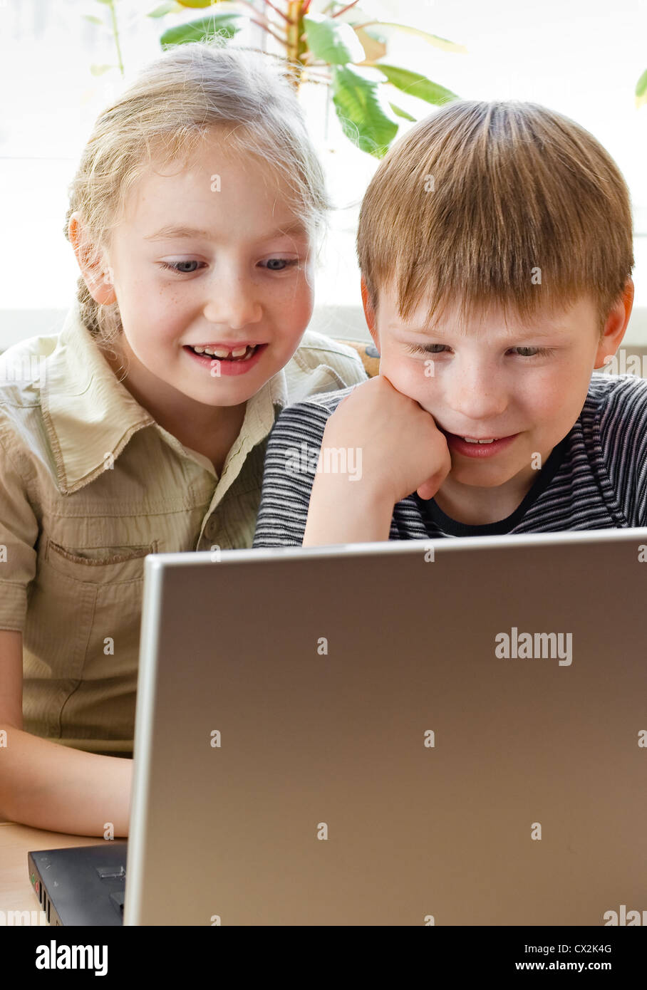 School boy and girl portrait looking at notebook Stock Photo - Alamy