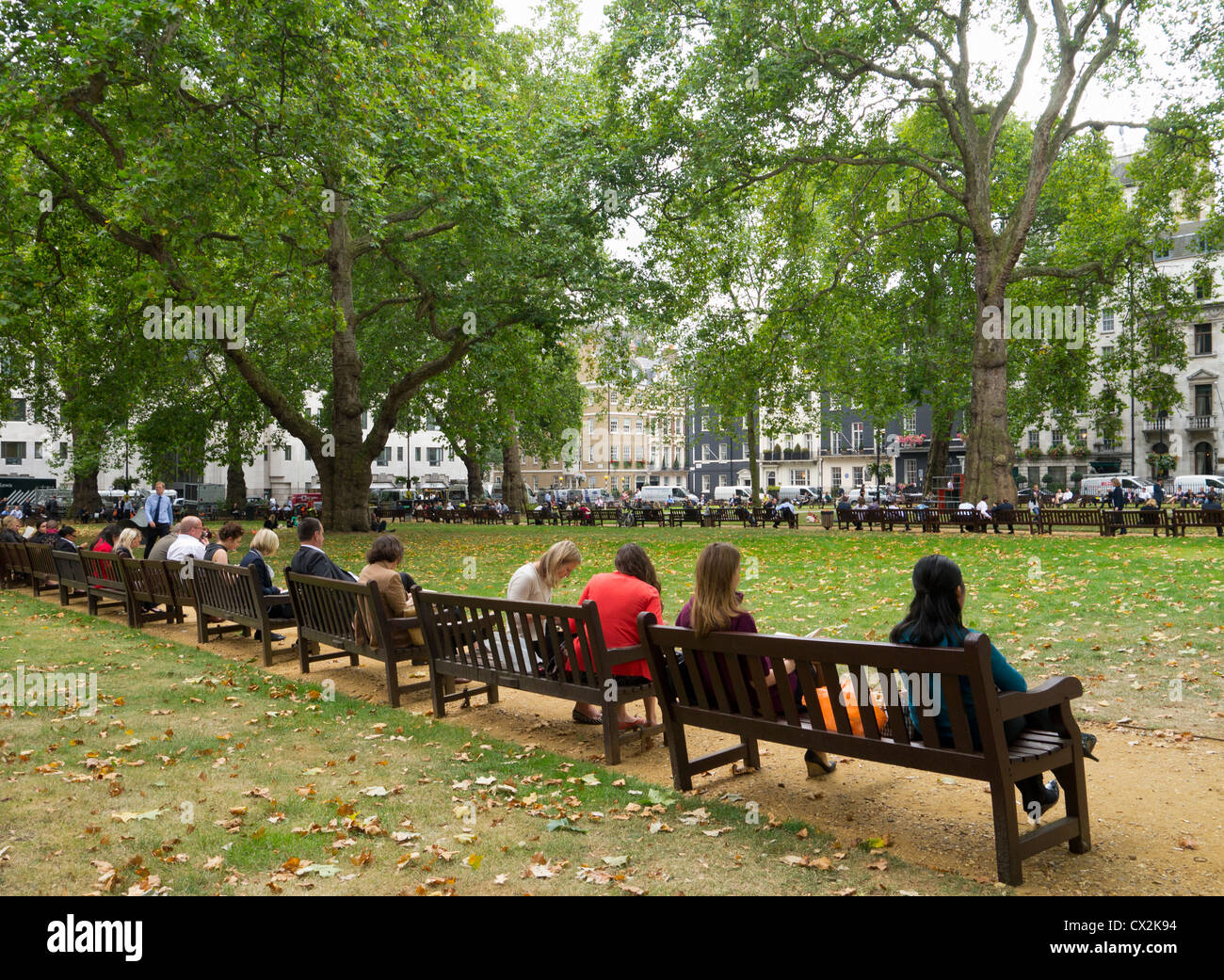 Berkeley Square in Westminster London. Lots of people sat outside ...