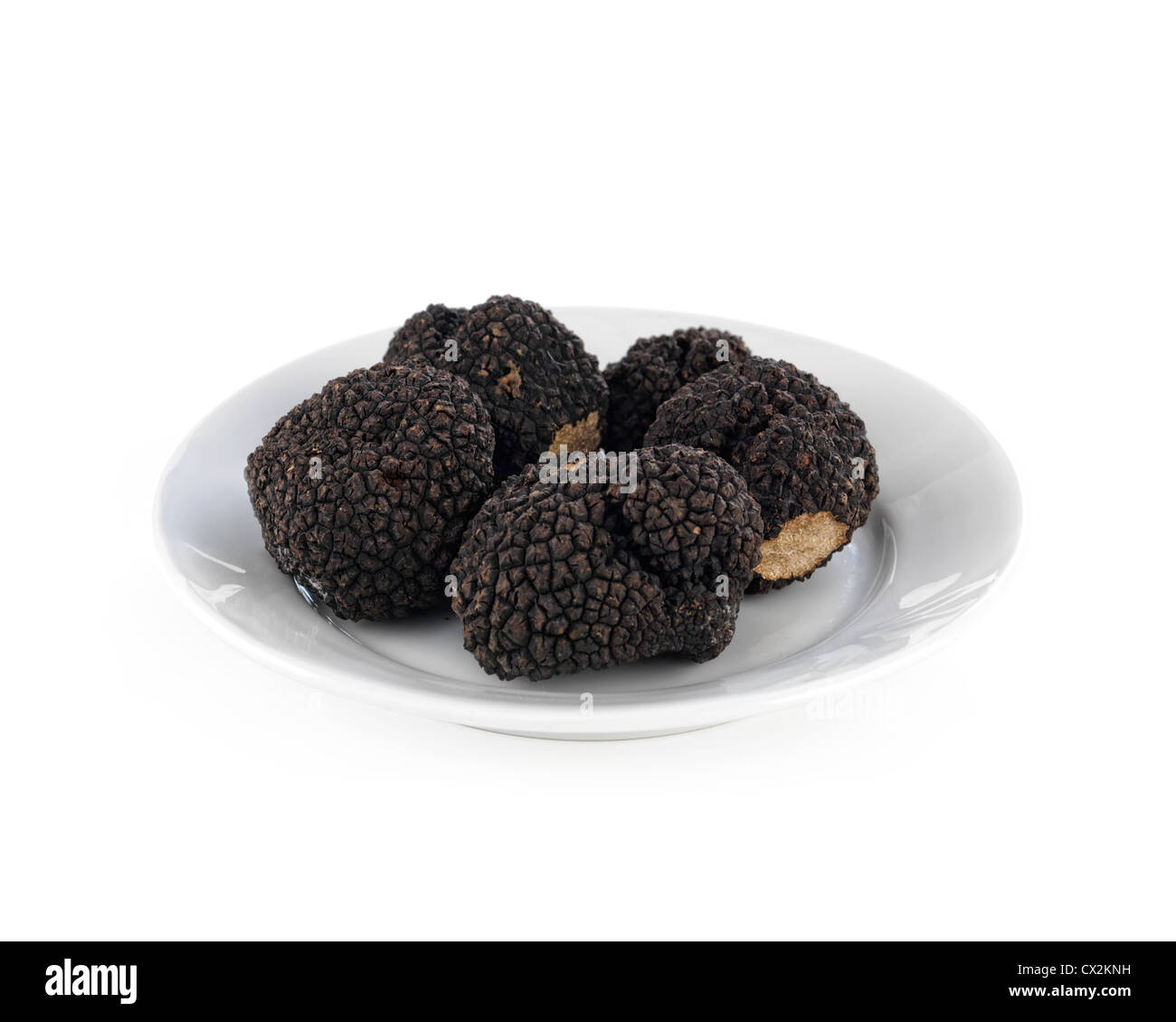 truffle on white plate on white background Stock Photo - Alamy