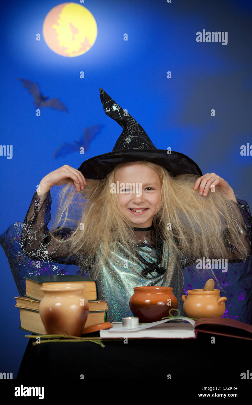 Girl dressed up as witch in night making magic Stock Photo - Alamy