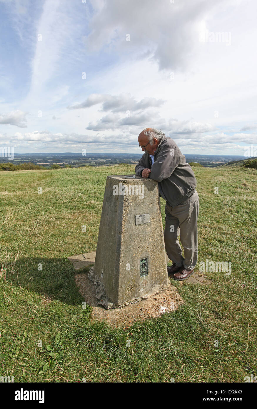 Man reading the information on the stone plinth at the top of Ditchling ...