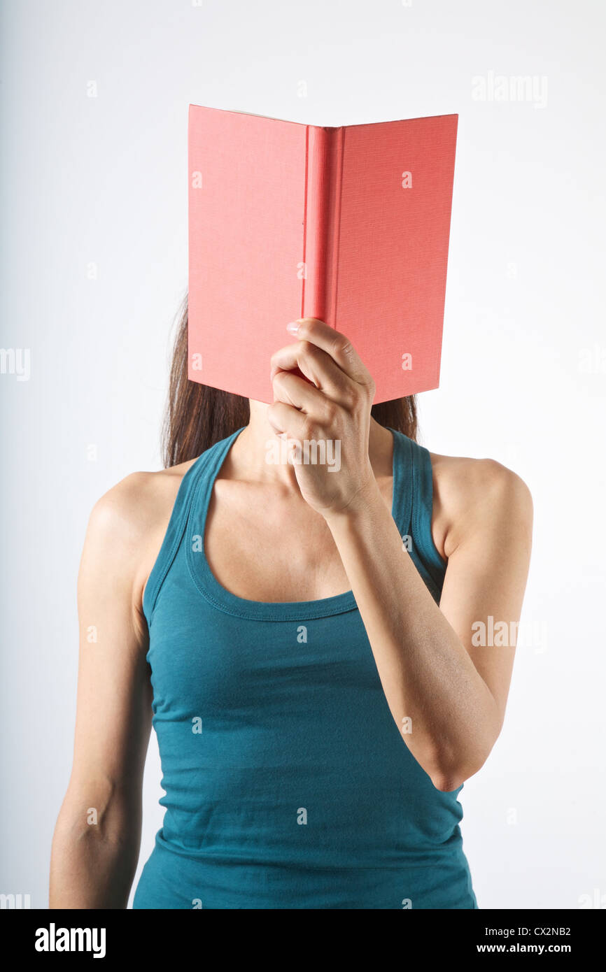 woman with a book in her face on white background Stock Photo - Alamy