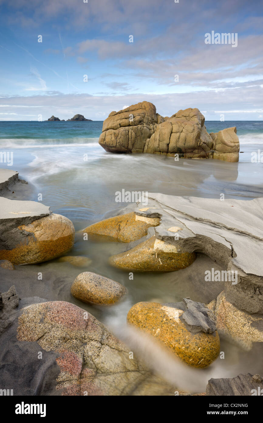 Smooth granite boulders on the sandy beach at Porth Nanven, Cornwall ...