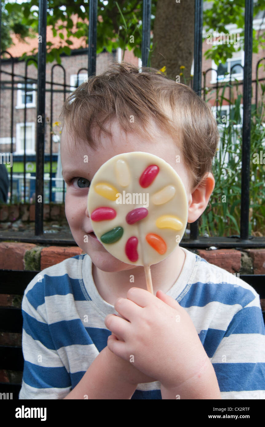 Small boy with a chocolate lollipop Stock Photo - Alamy
