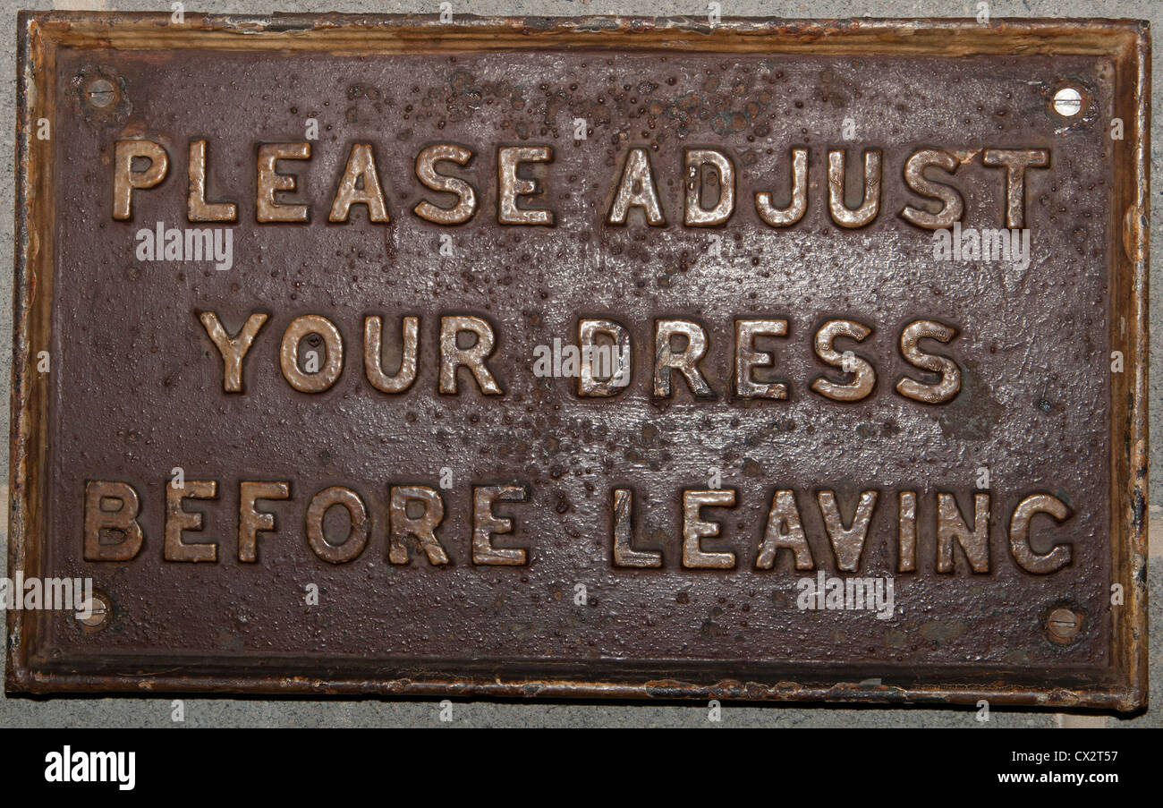 Please adjust your dress before leaving railway sign Stock Photo - Alamy