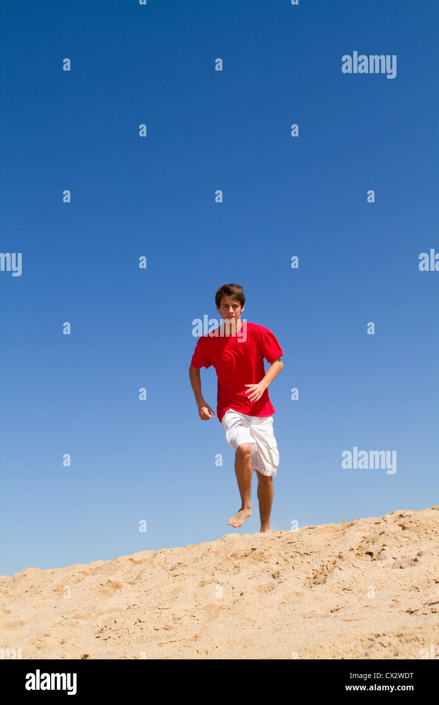 active teen boy running on beach Stock Photo - Alamy
