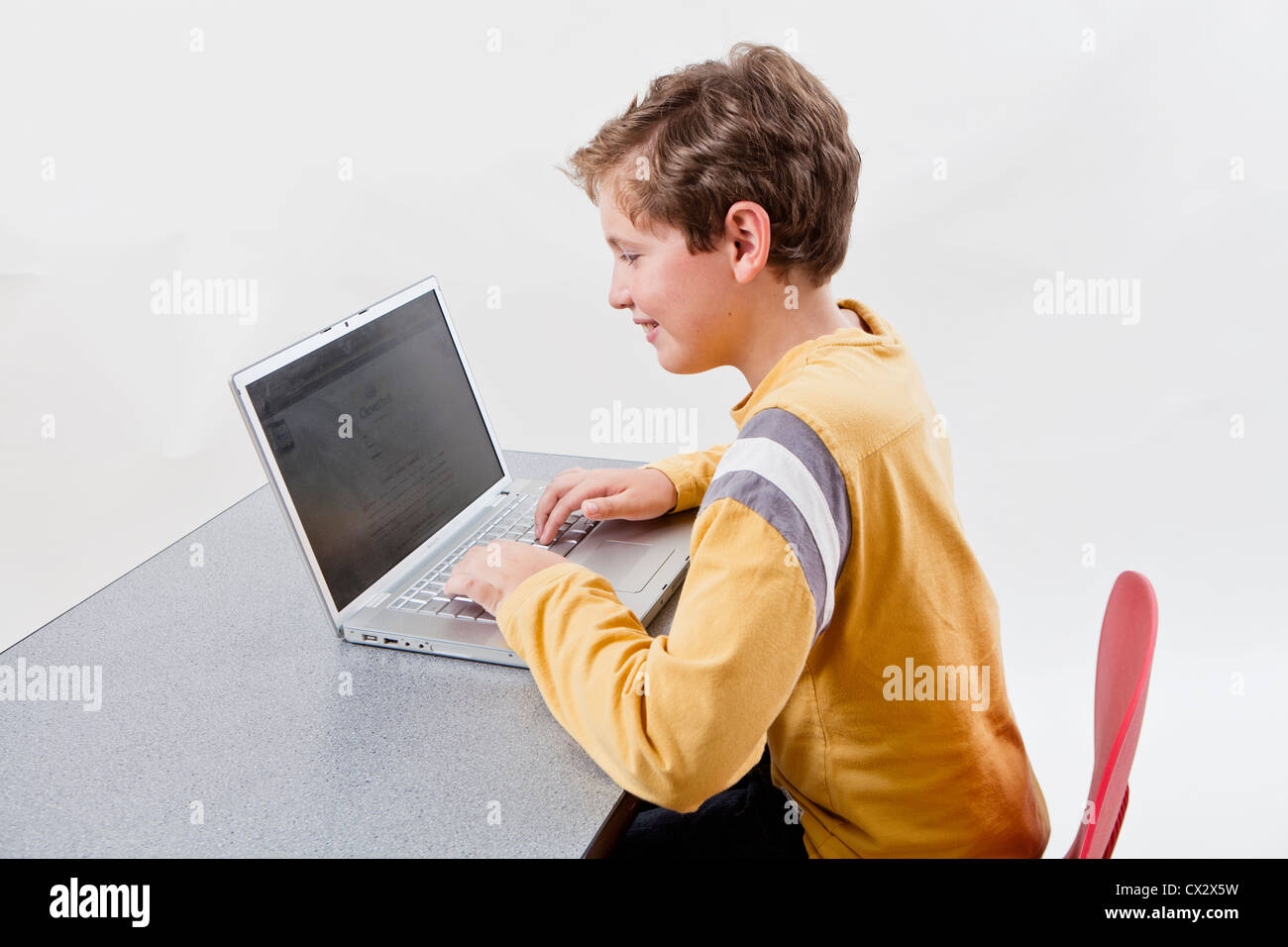 Young boy using a laptop computer Stock Photo - Alamy