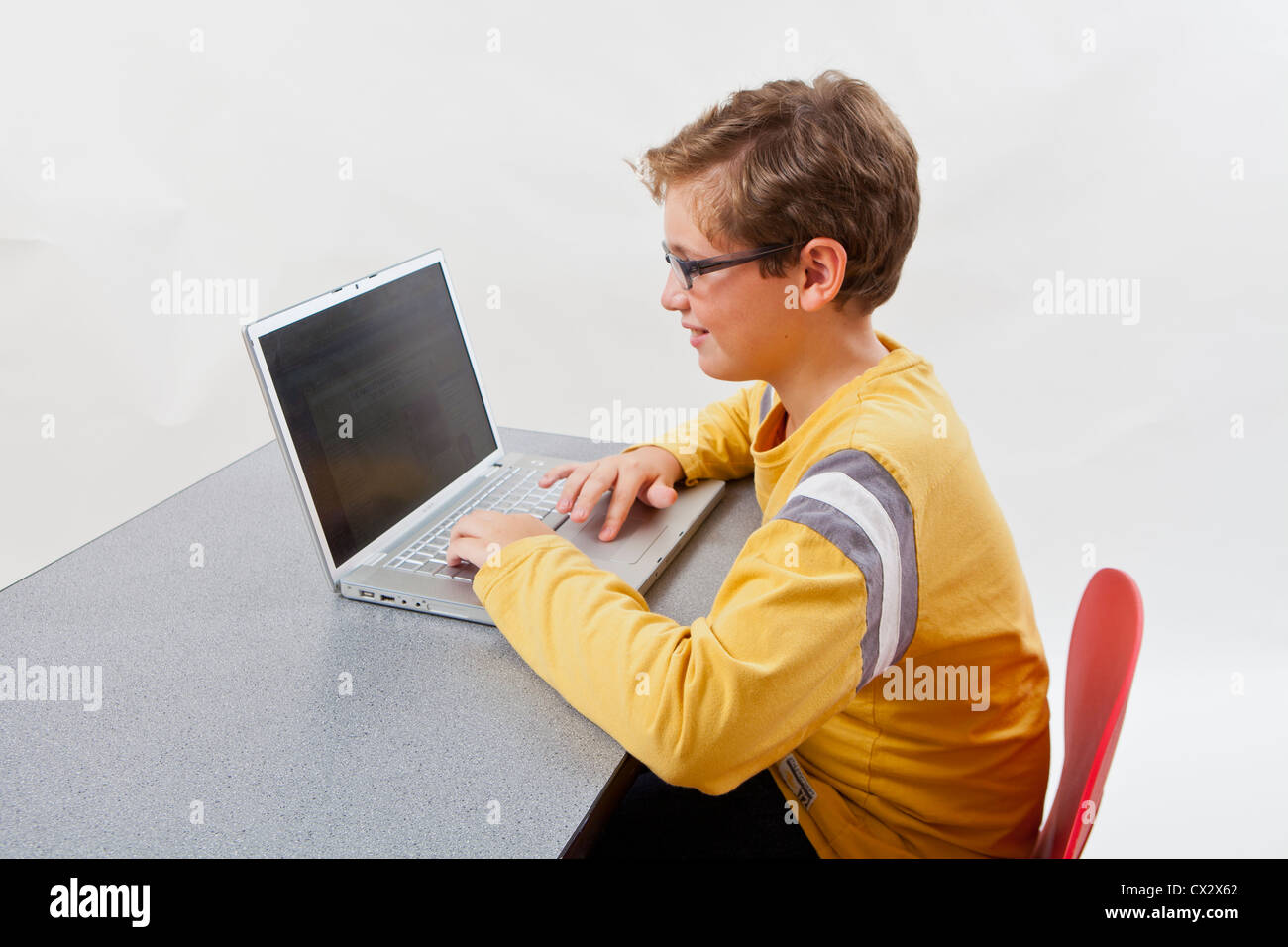Young boy using a laptop computer Stock Photo - Alamy
