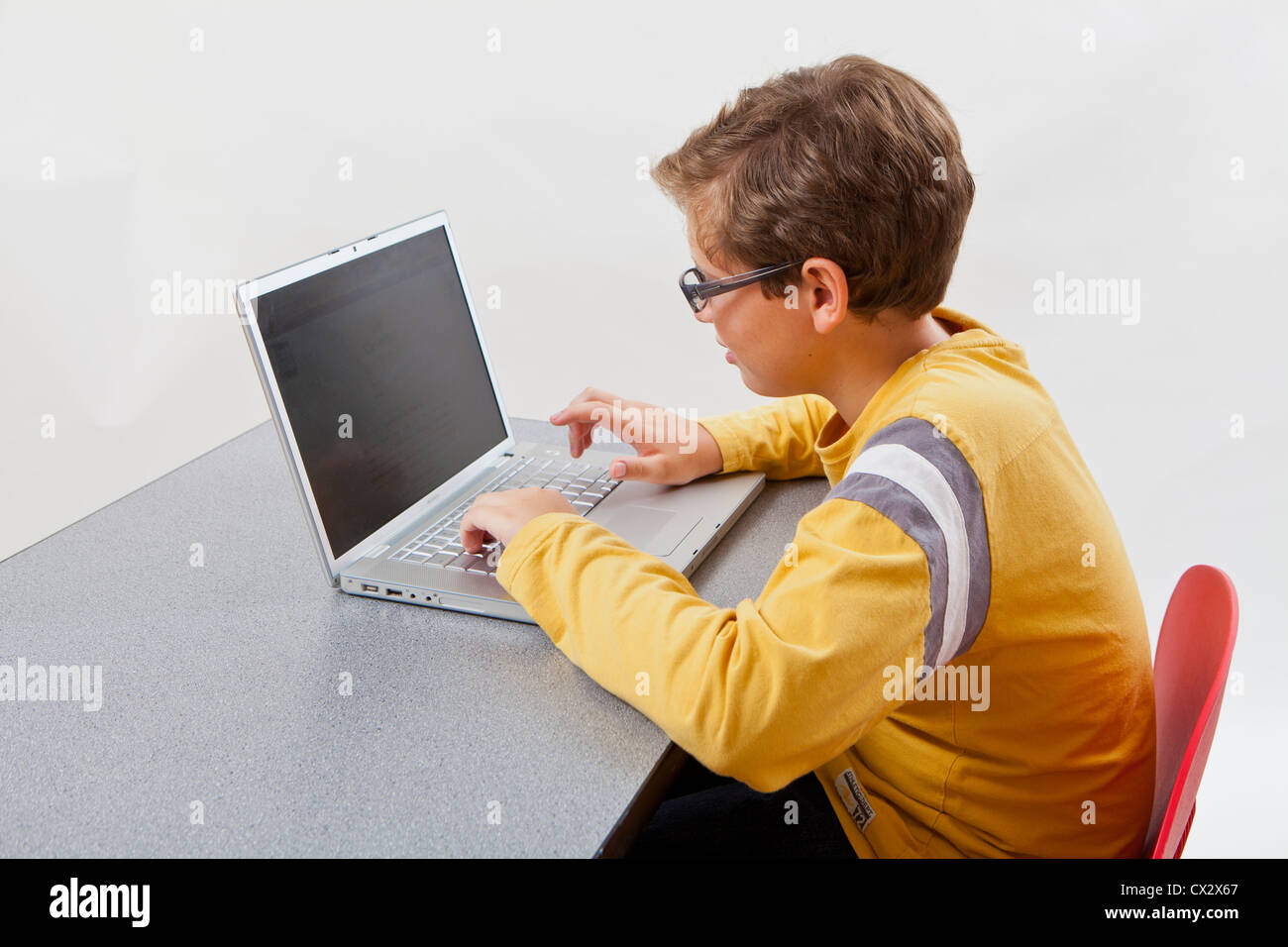 Young boy using a laptop computer Stock Photo - Alamy