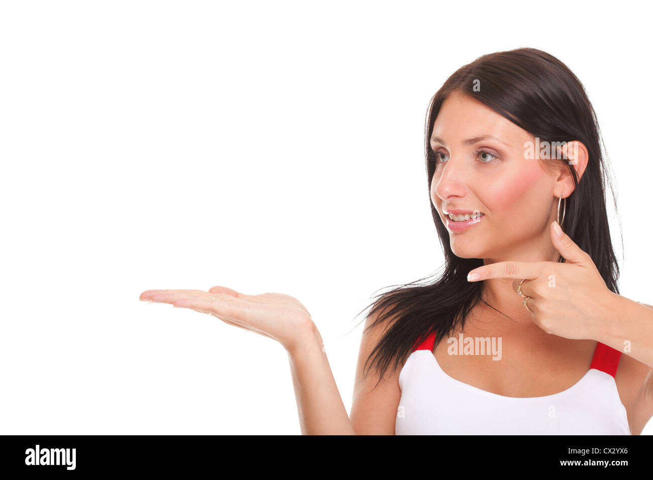 Young woman showing product with open hand palm - excited expression on ...