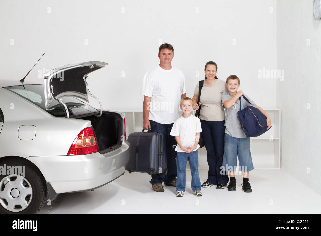 happy family standing next to family car and ready for a fun road trip ...