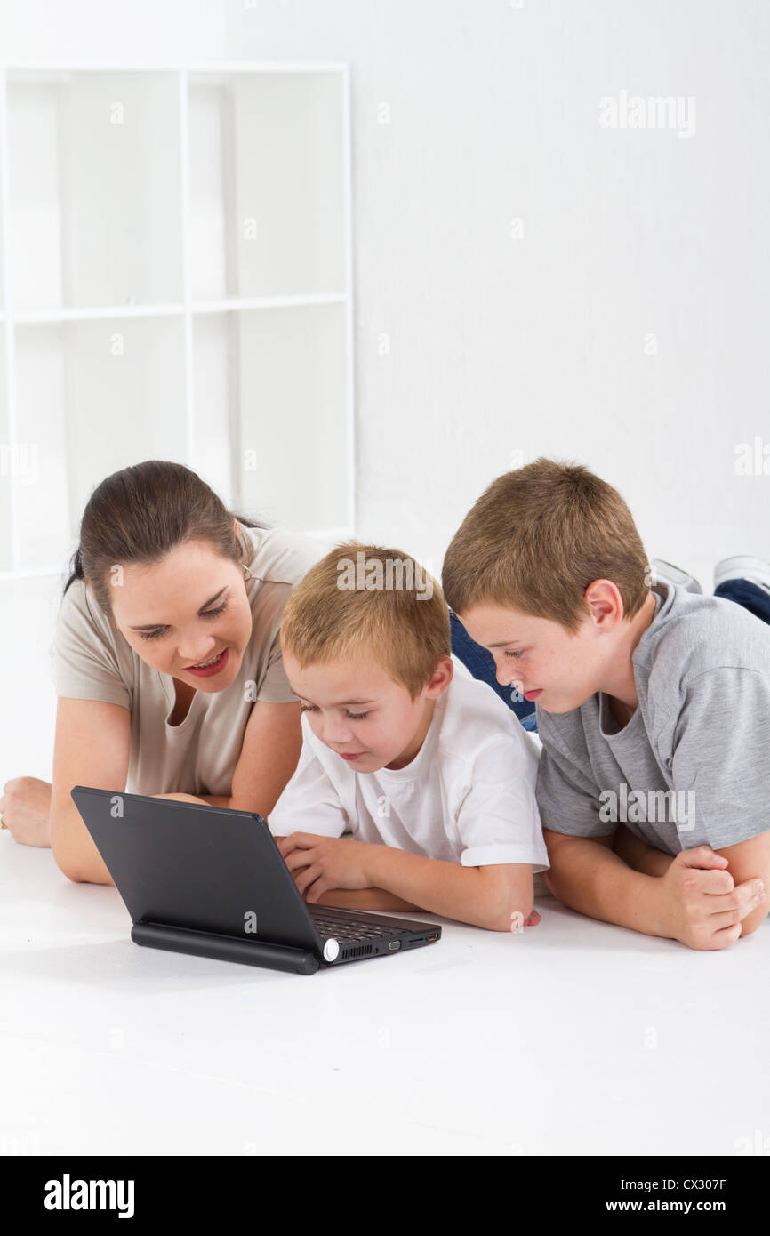 mother and her boys using laptop computer on floor Stock Photo - Alamy