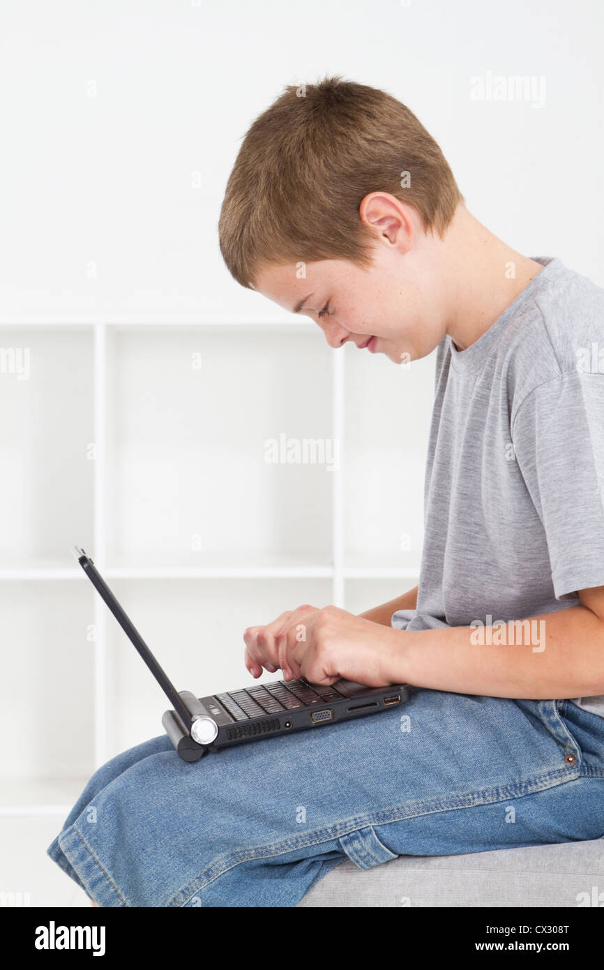 teen boy using laptop computer indoor Stock Photo - Alamy