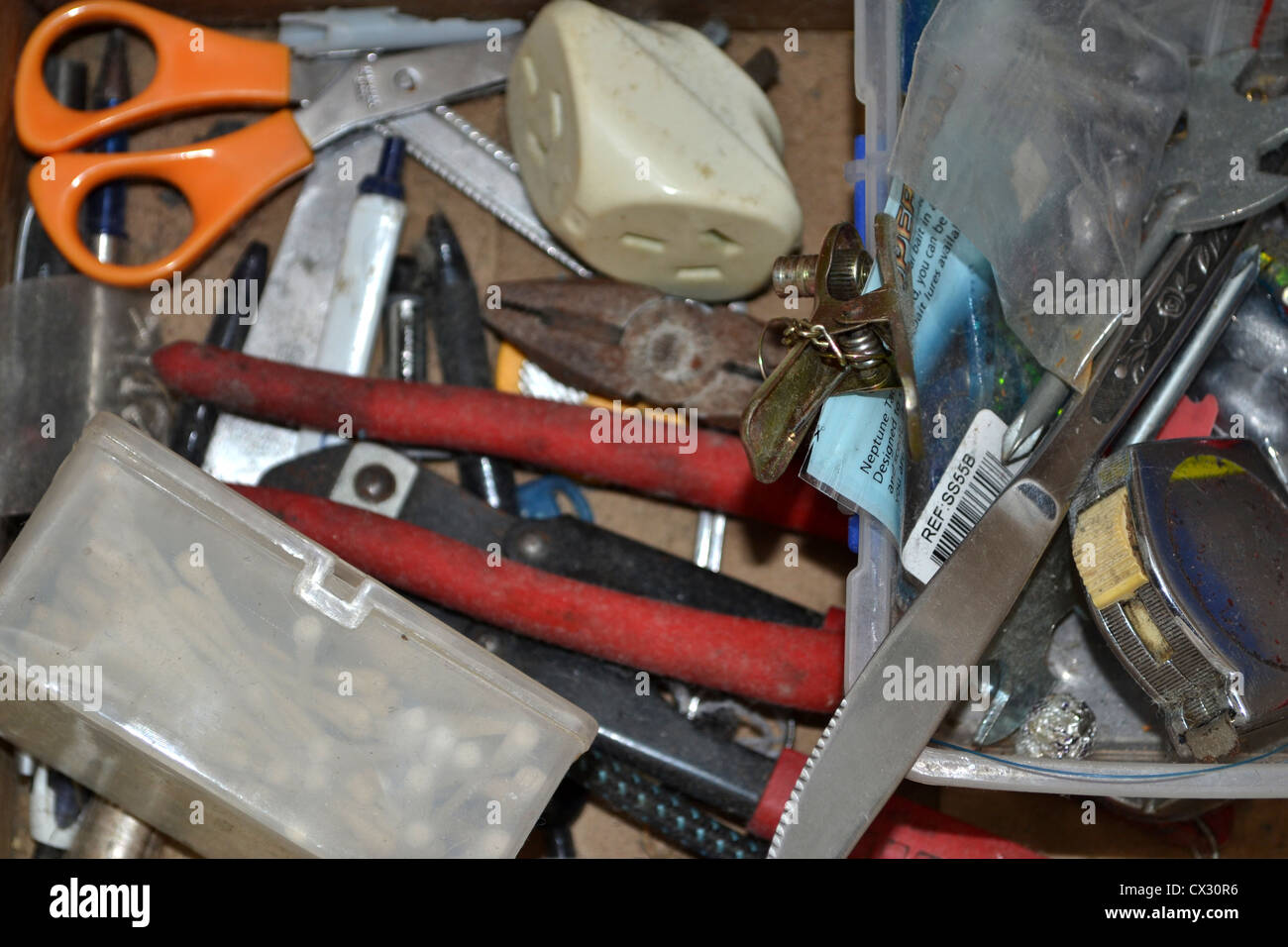 assorted tools and parts at the bottom of a dusty box Stock Photo - Alamy
